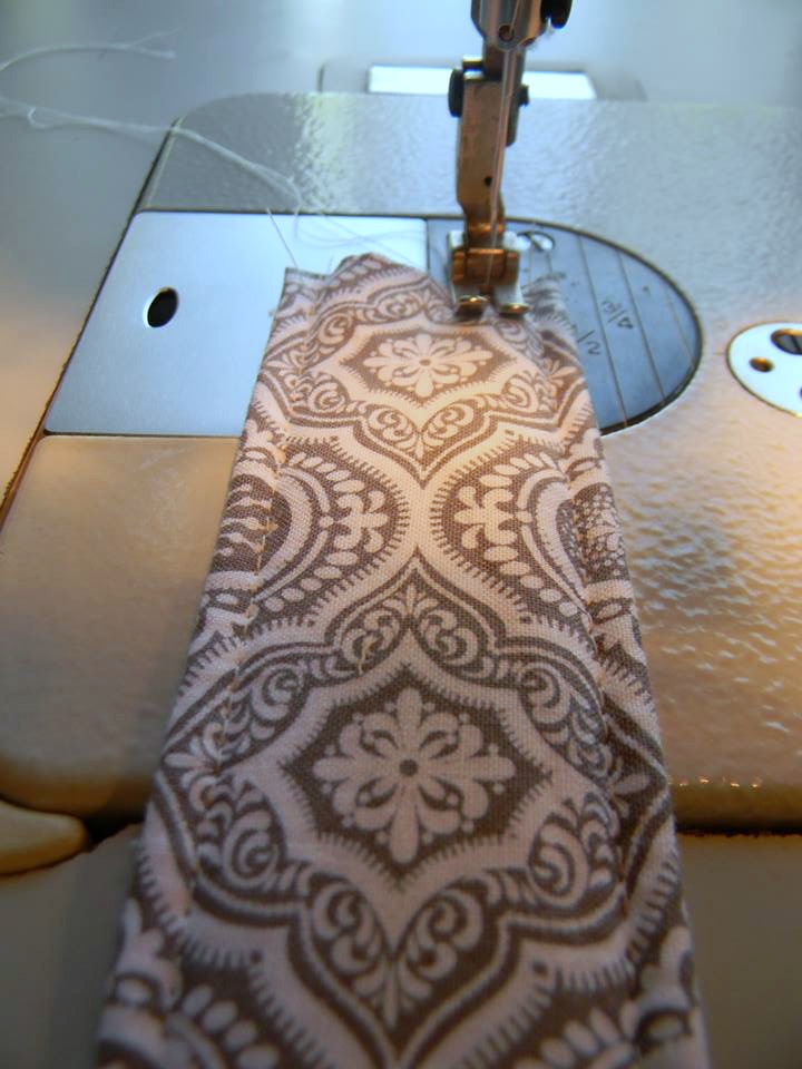 Step 9: Feed one end through one piece of hardware. Fold the strap end ...