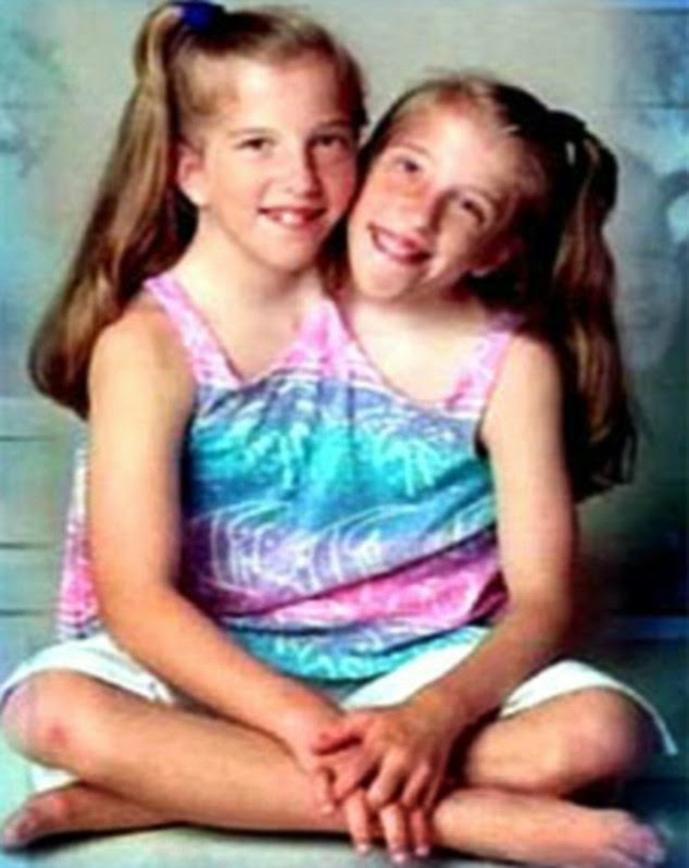 JALWAH: This girl has two heads. Or these two girls have one body