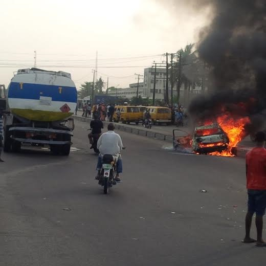Photos: Man rescued after his car goes up in flame in Lagos this morning