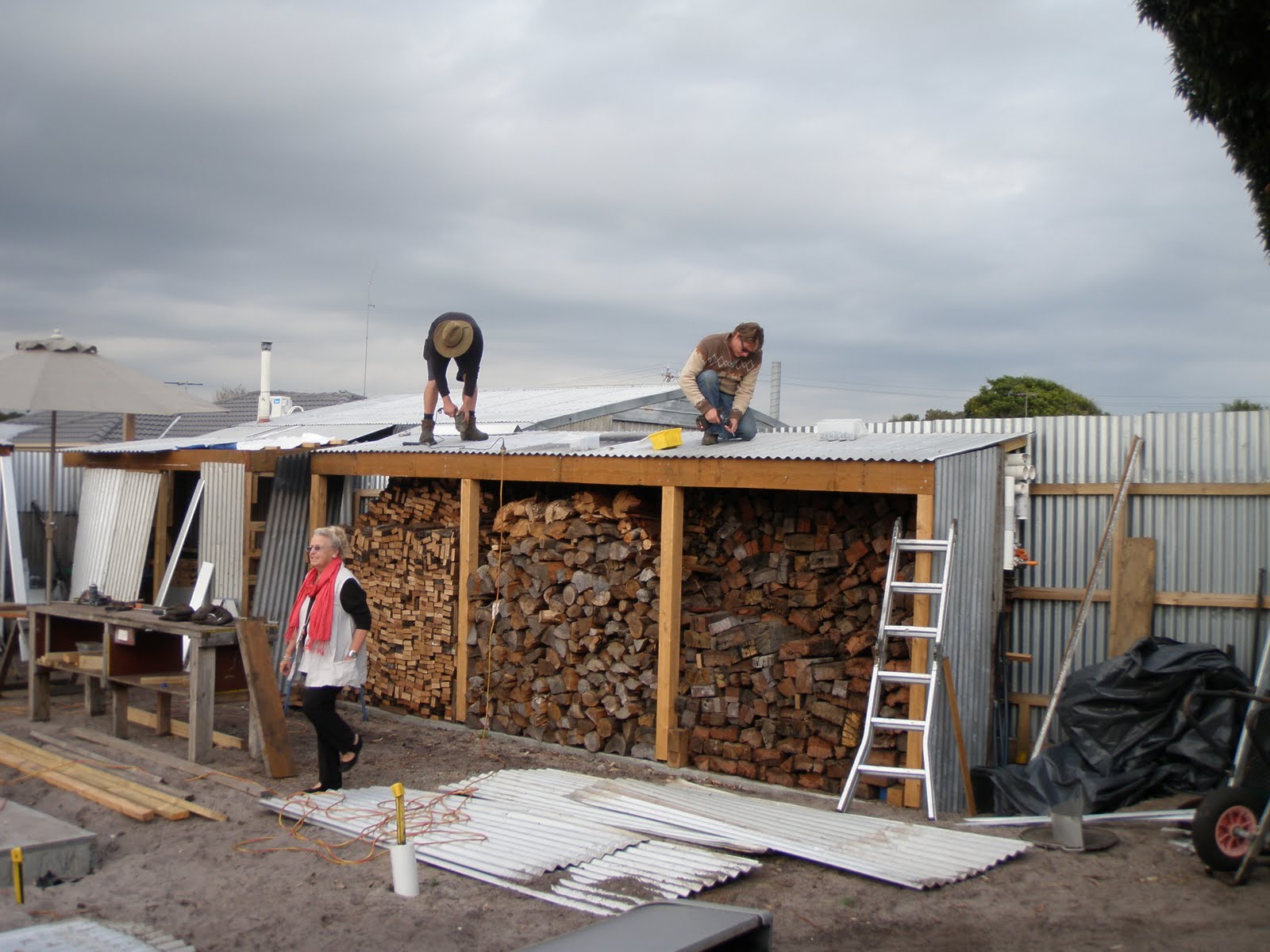 Suburban Strawbale: Wood pile and sheds