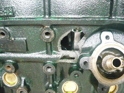Engine destroyed with piston through block wall