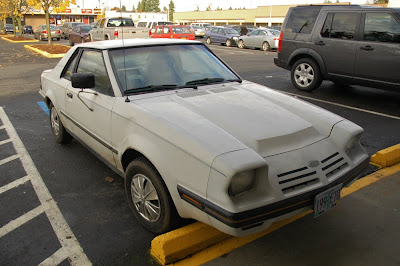 OLD PARKED CARS.: 1984 Ford EXP.