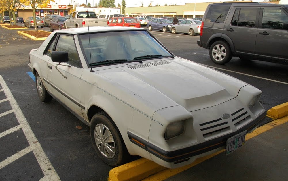 OLD PARKED CARS.: 1984 Ford EXP.