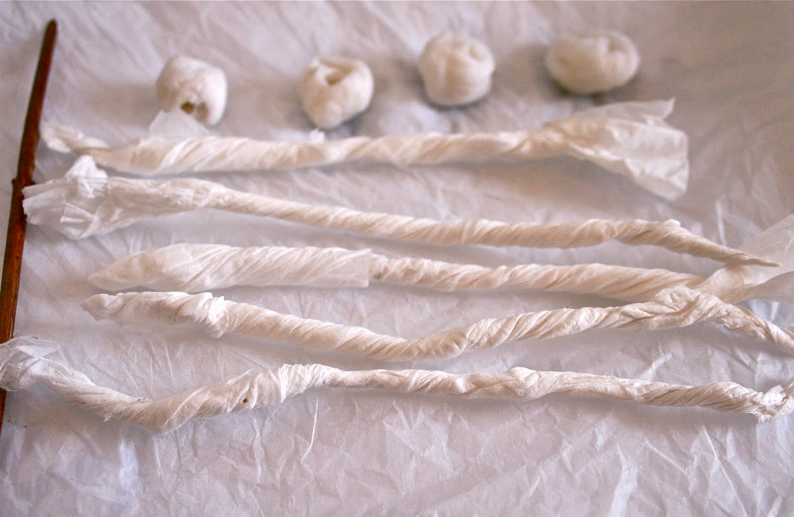 Hilary Bravo: Making plain white papier-mâché beads - ready for decorating.
