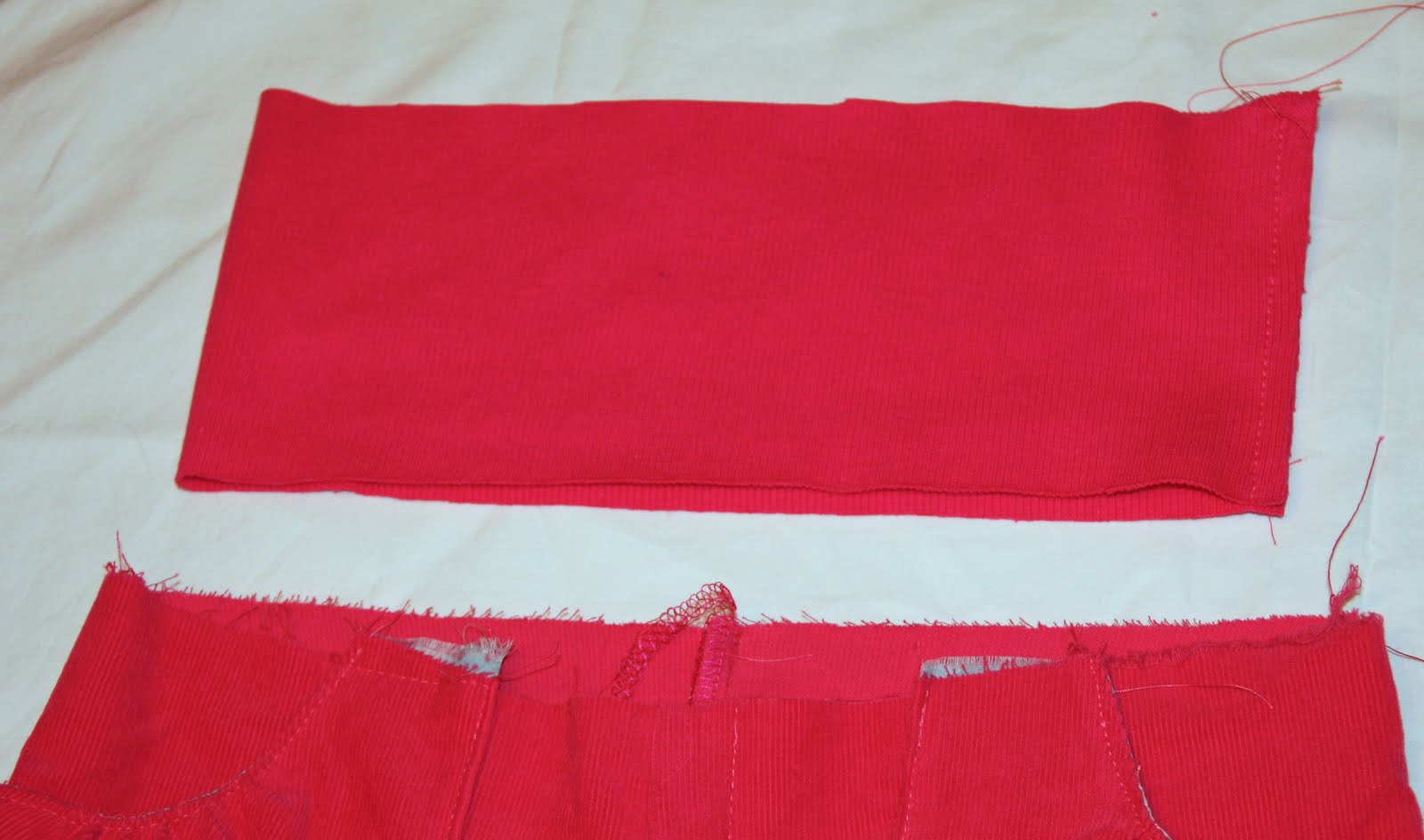 Lay the ribbing band onto the waist of the pants, right sides together ...