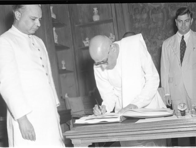 C. Rajagopalachari signing the register after he had taken his oath of ...