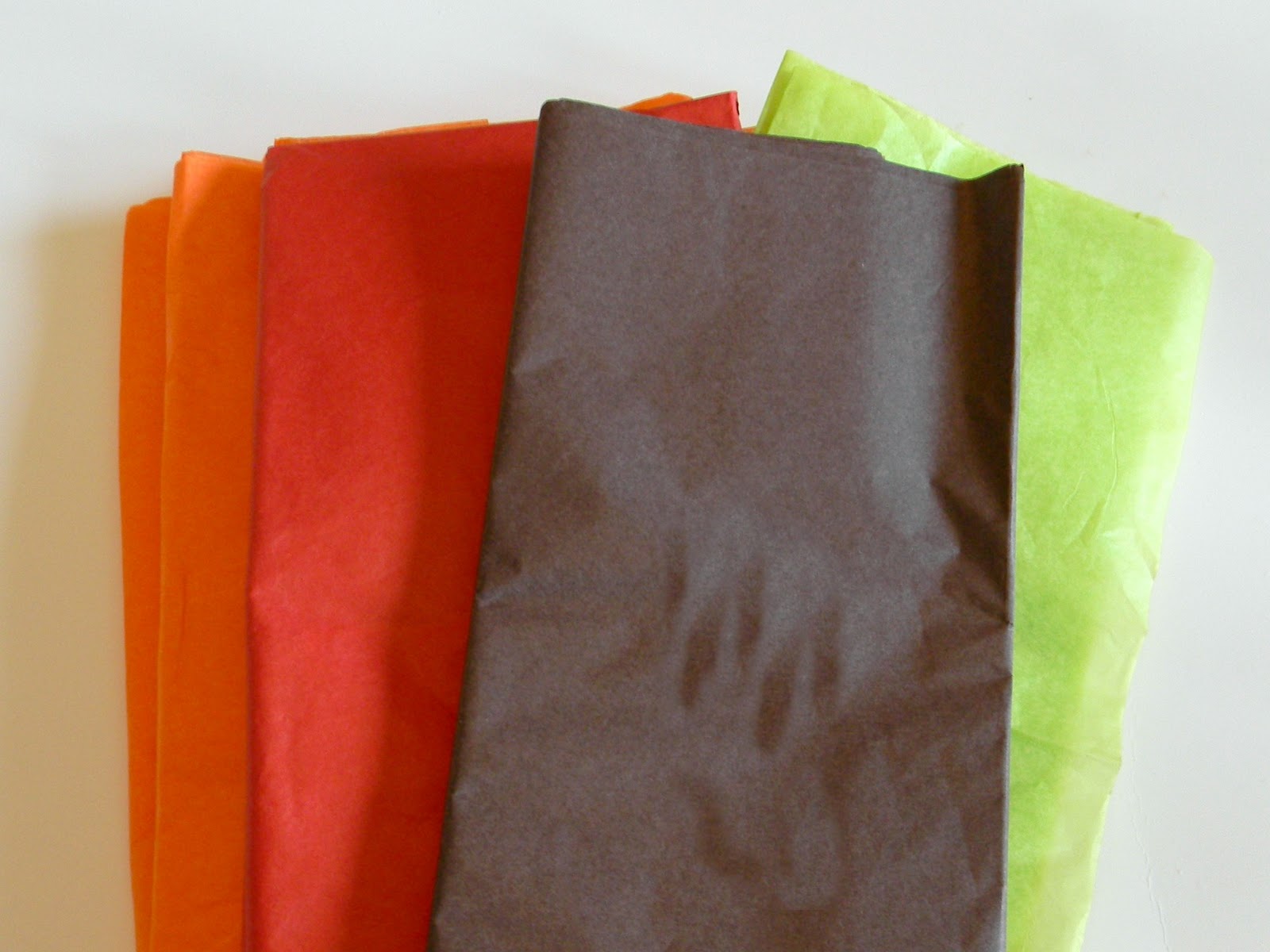 Fold your tissue paper up and punch out some leaves. It’s necessary to ...